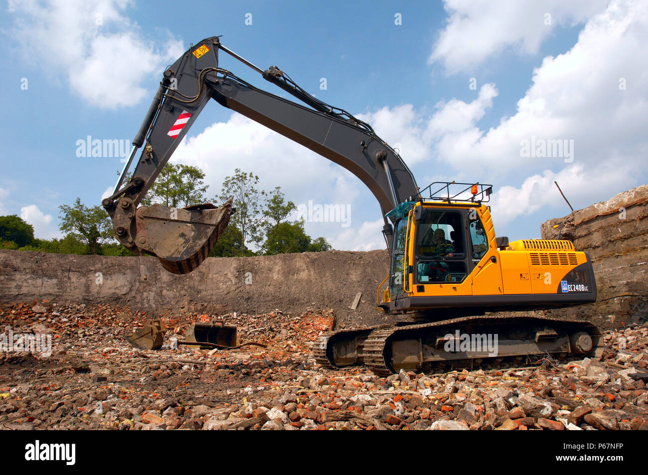 Crawler excavator working in the remains of Victorian gas tank Stock ...
