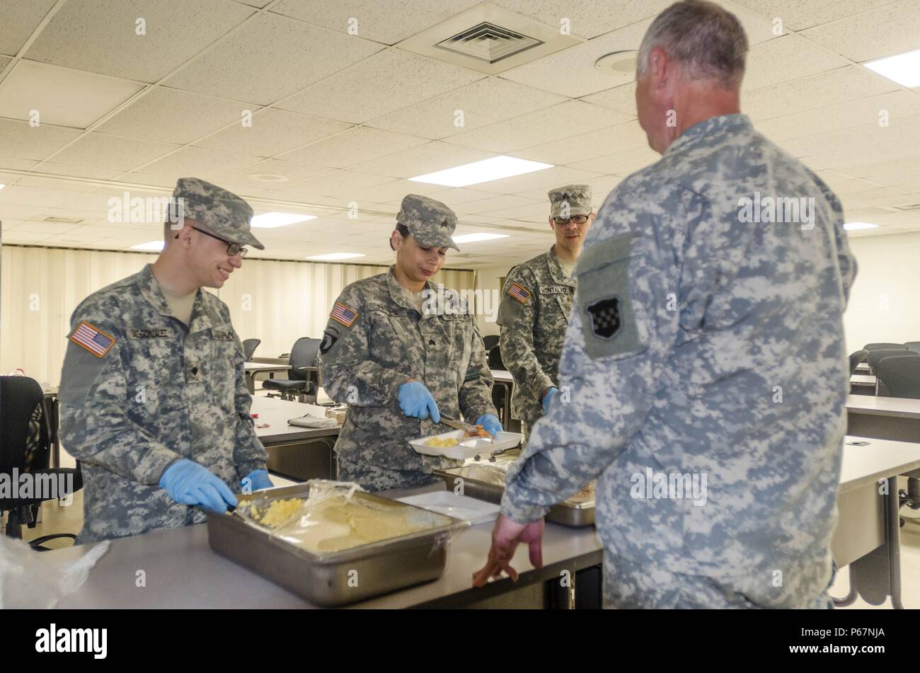 Sgt. Silverina Reyes, Sgt. Edgardo Montalvo and Spc. Jorge Diaz-Gonzalez serve breakfast to Task ...