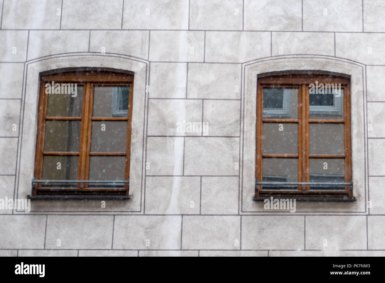 Snow falling with windows, building on the background Stock Photo - Alamy