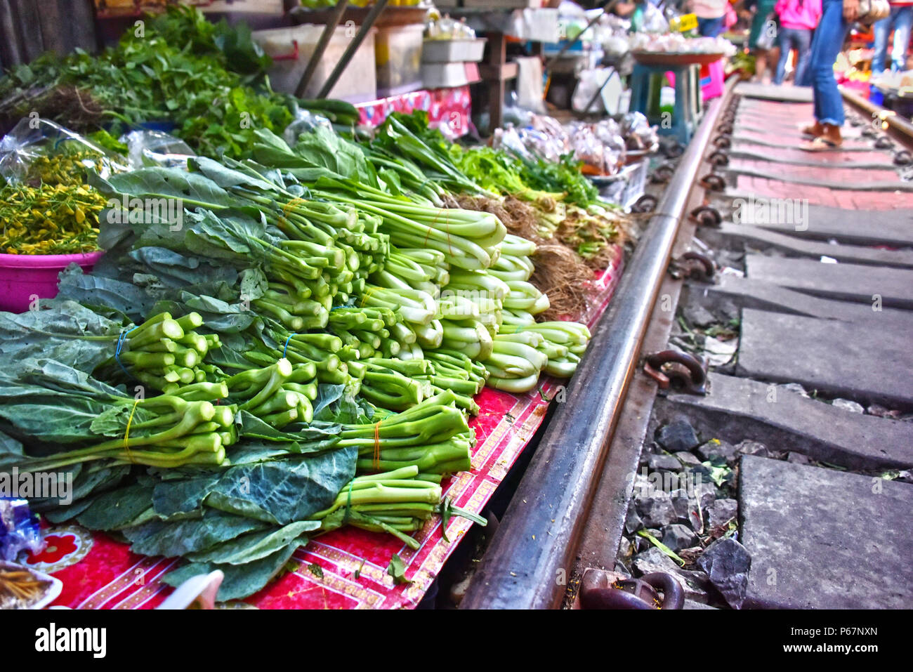 Selling food on the Maeklong Railway market in Thailand Stock Photo - Alamy