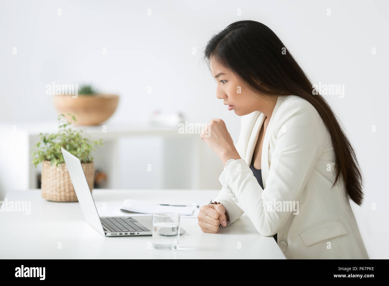 Asian female feeling stunned after reading unexpected news Stock Photo ...