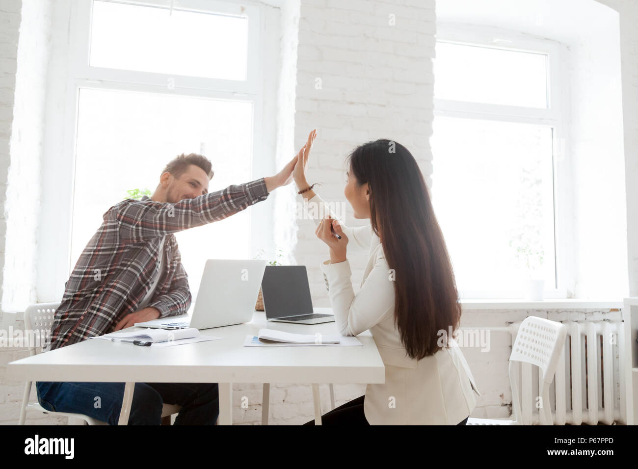 Celebrating success colleagues smiling hi-res stock photography and ...