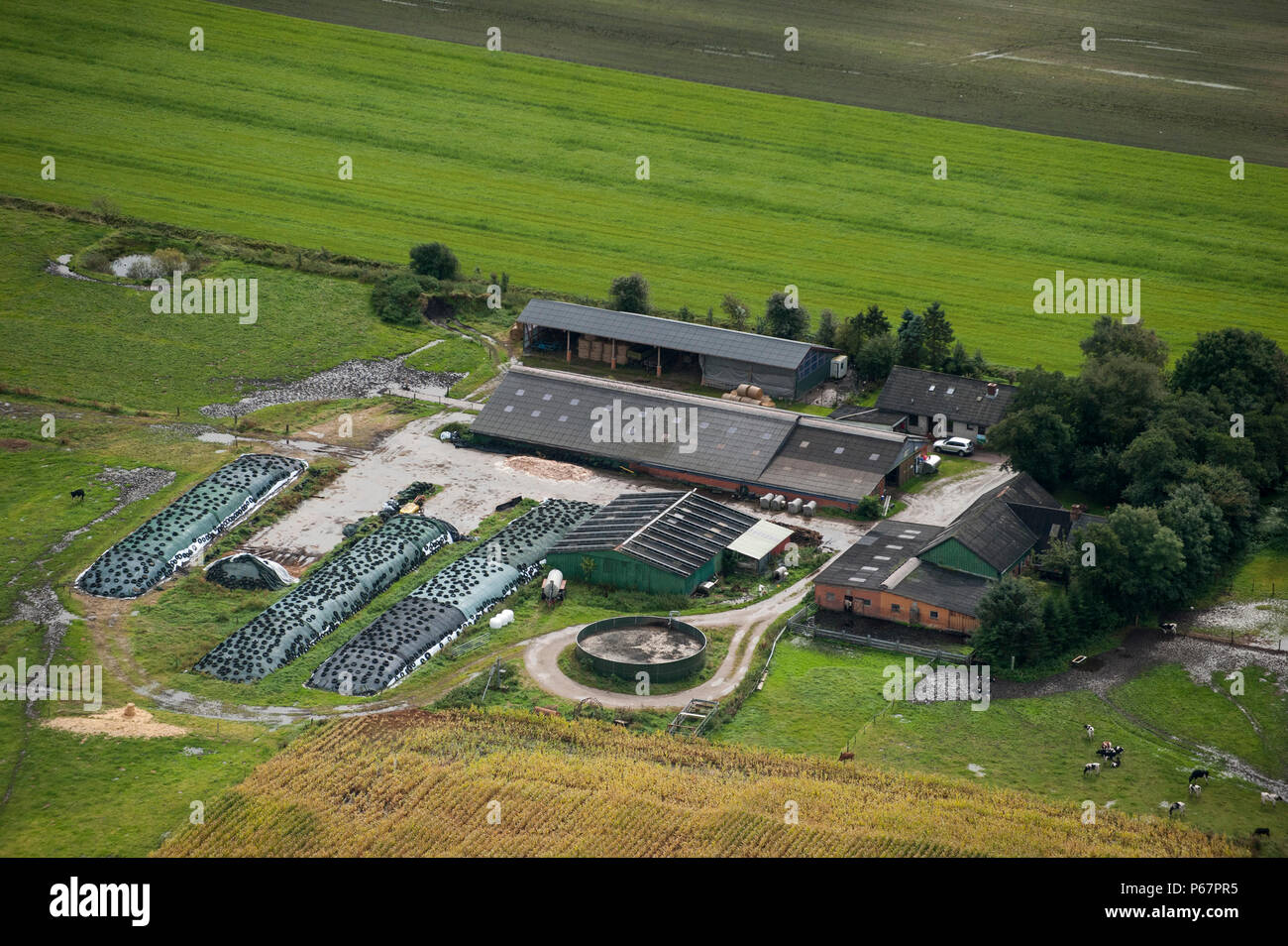 GERMANY aerial view of farm homestead with slurry tank and stable with ...
