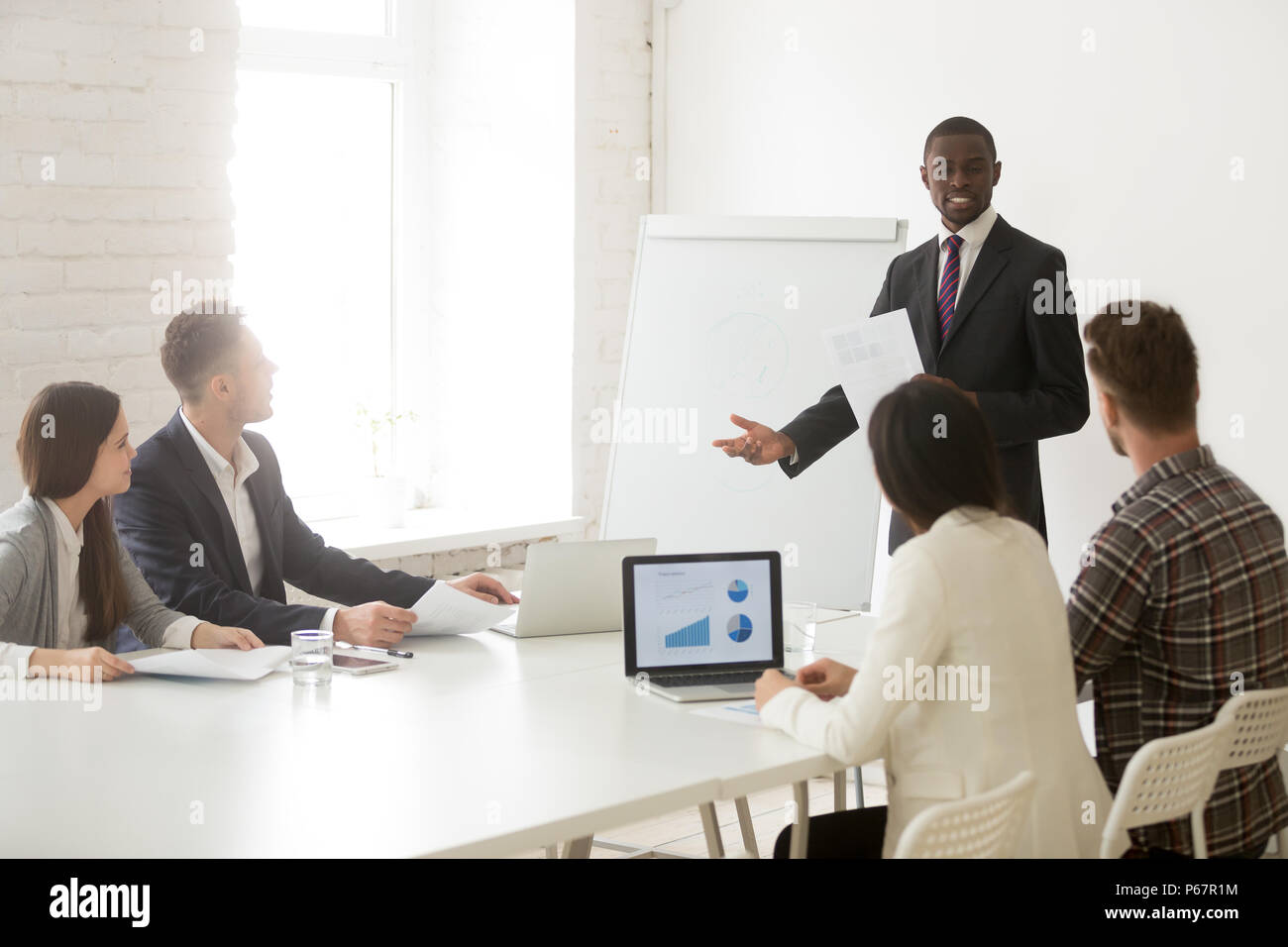 African American worker presenting in front of diverse colleague Stock ...