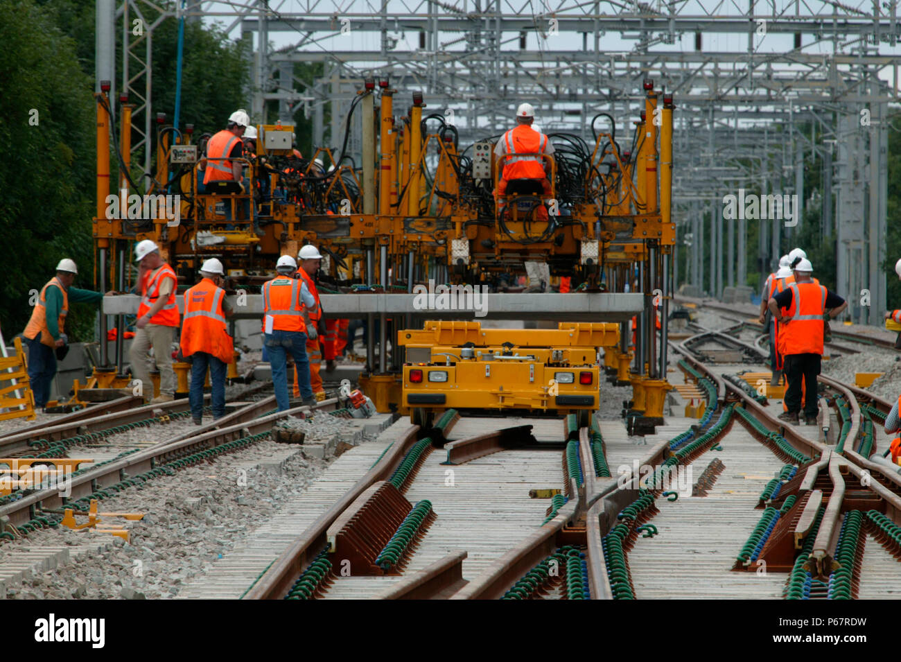 New track sections being lowered into place at Bourne End in August ...
