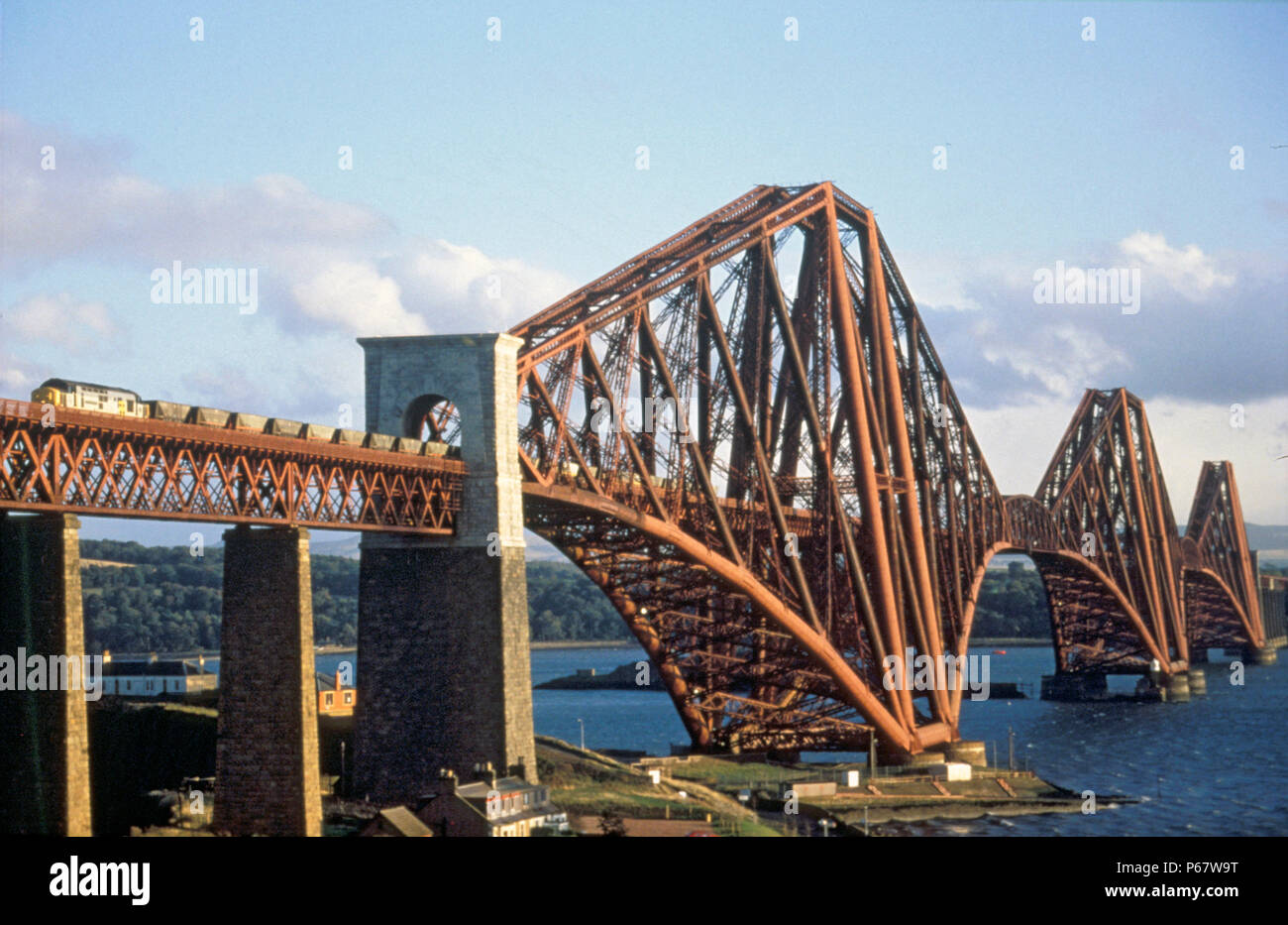 The Forth Bridge over the Firth of Forth with a coal train crossing ...