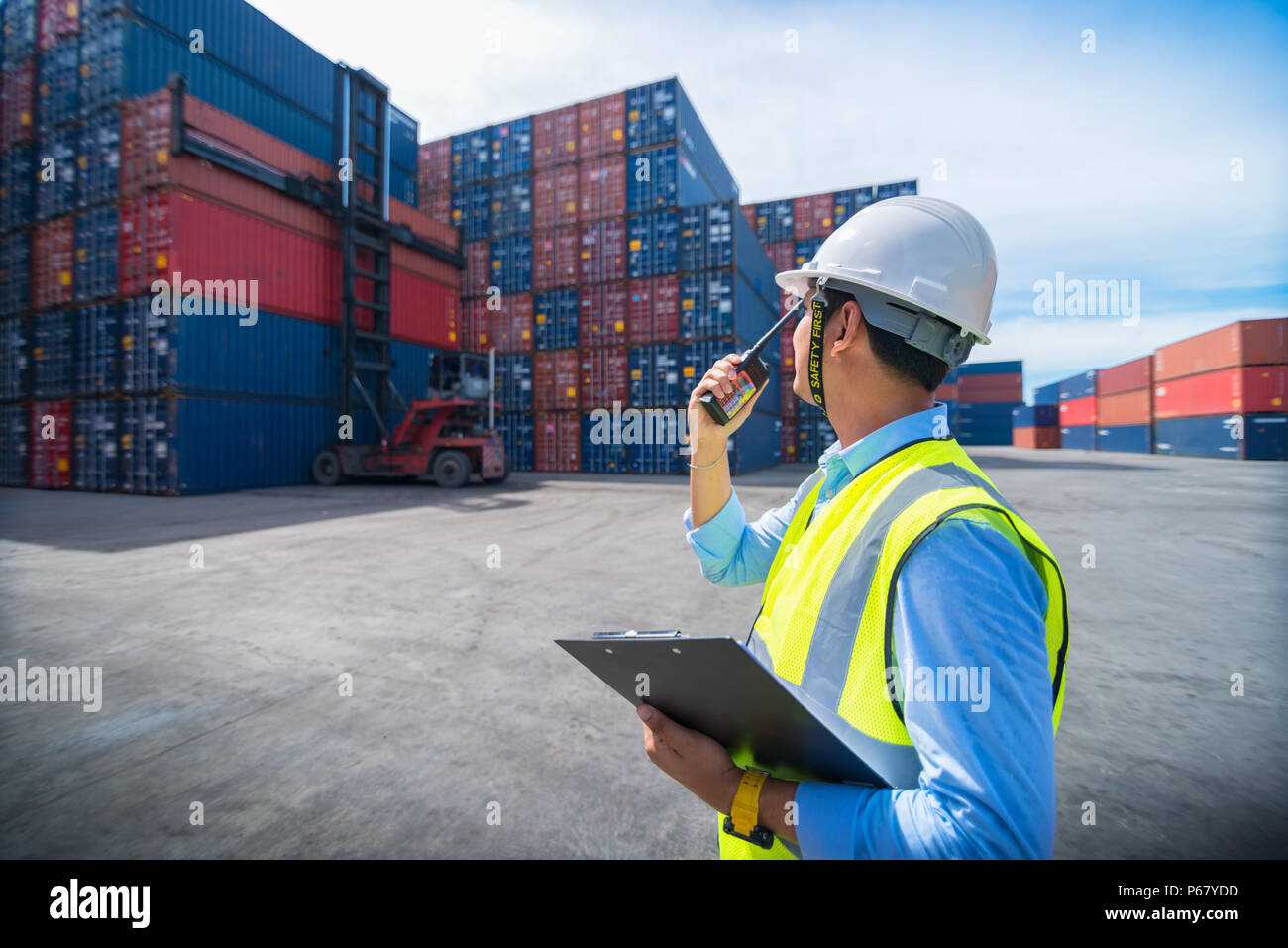 Foreman control loading containers box from cargo freight ship for ...