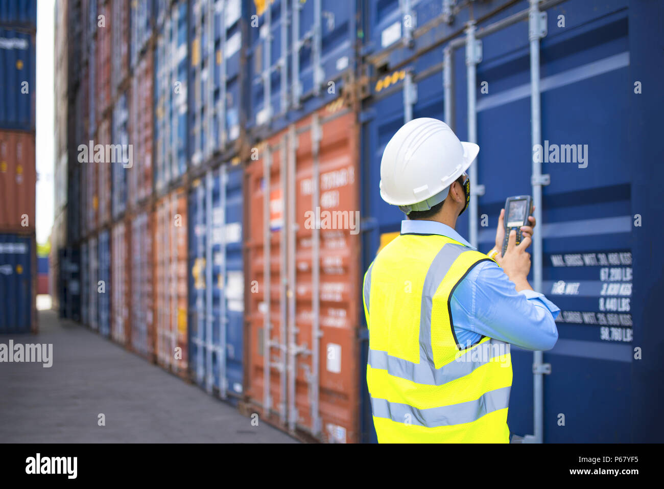 Foreman control loading containers box from cargo freight ship for ...