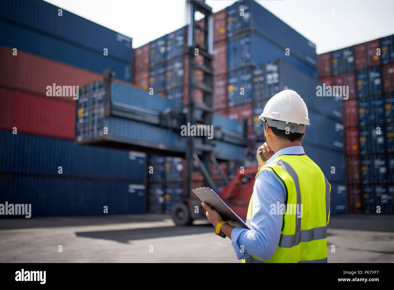 Foreman control loading containers box from cargo freight ship for ...