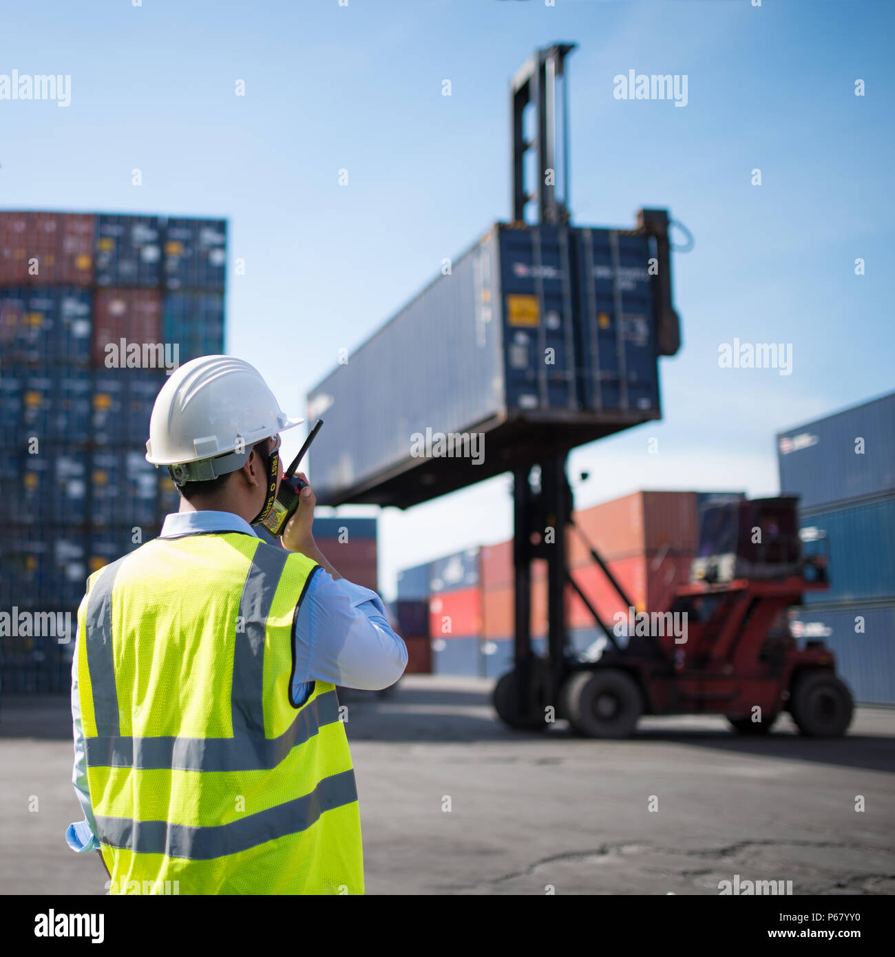 Foreman control loading containers box from cargo freight ship for ...