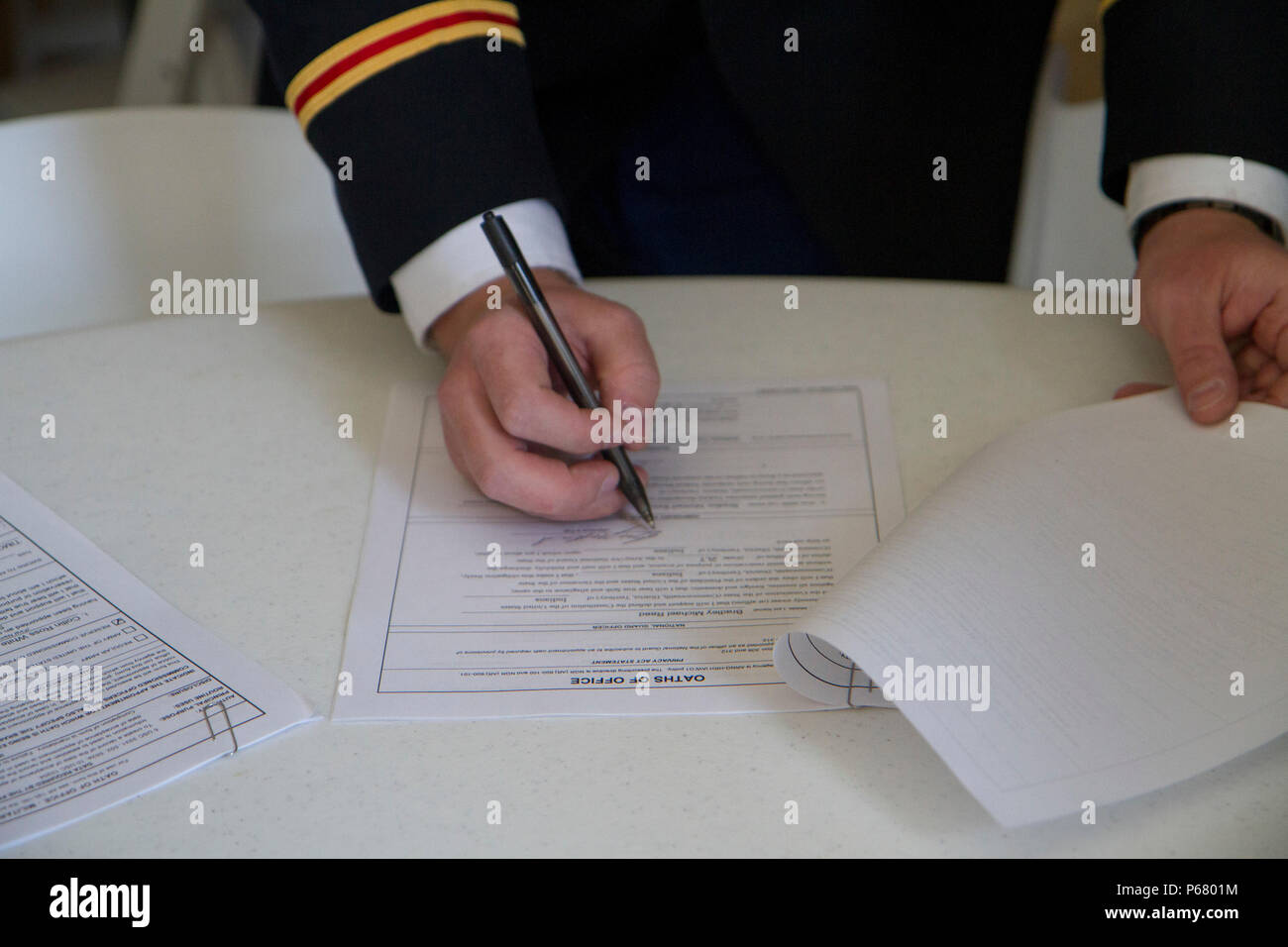 A cadet signs the official document acknowledging him as an officer in ...