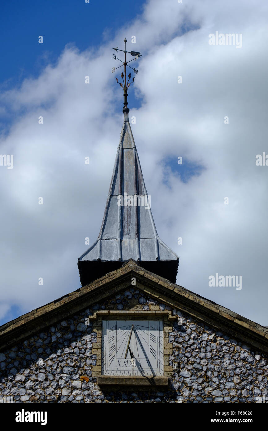 Old school weather vane and sun dial against a blue sky Stock Photo - Alamy