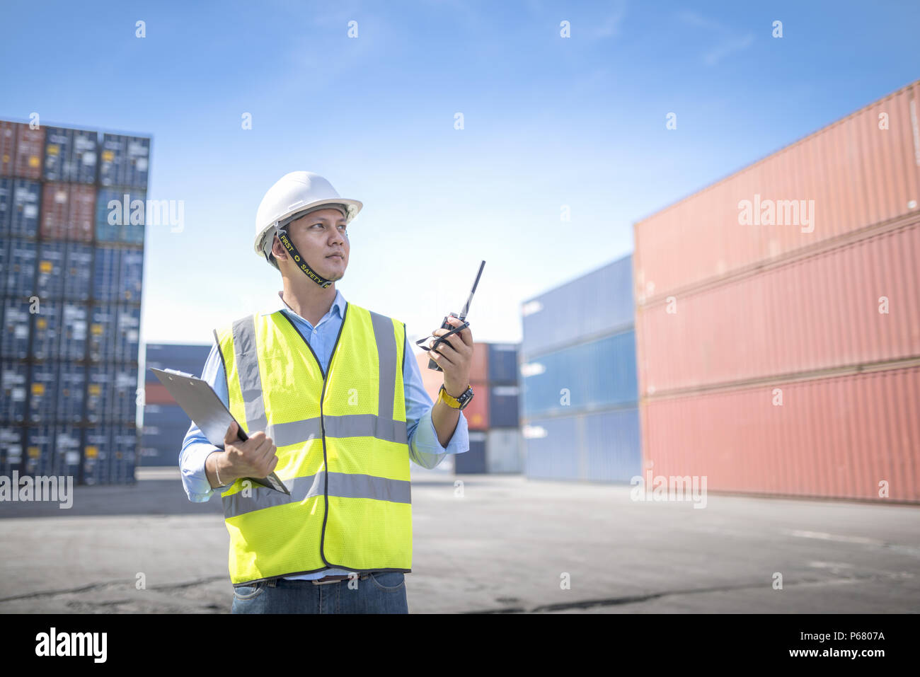 Foreman control loading containers box from cargo freight ship for ...