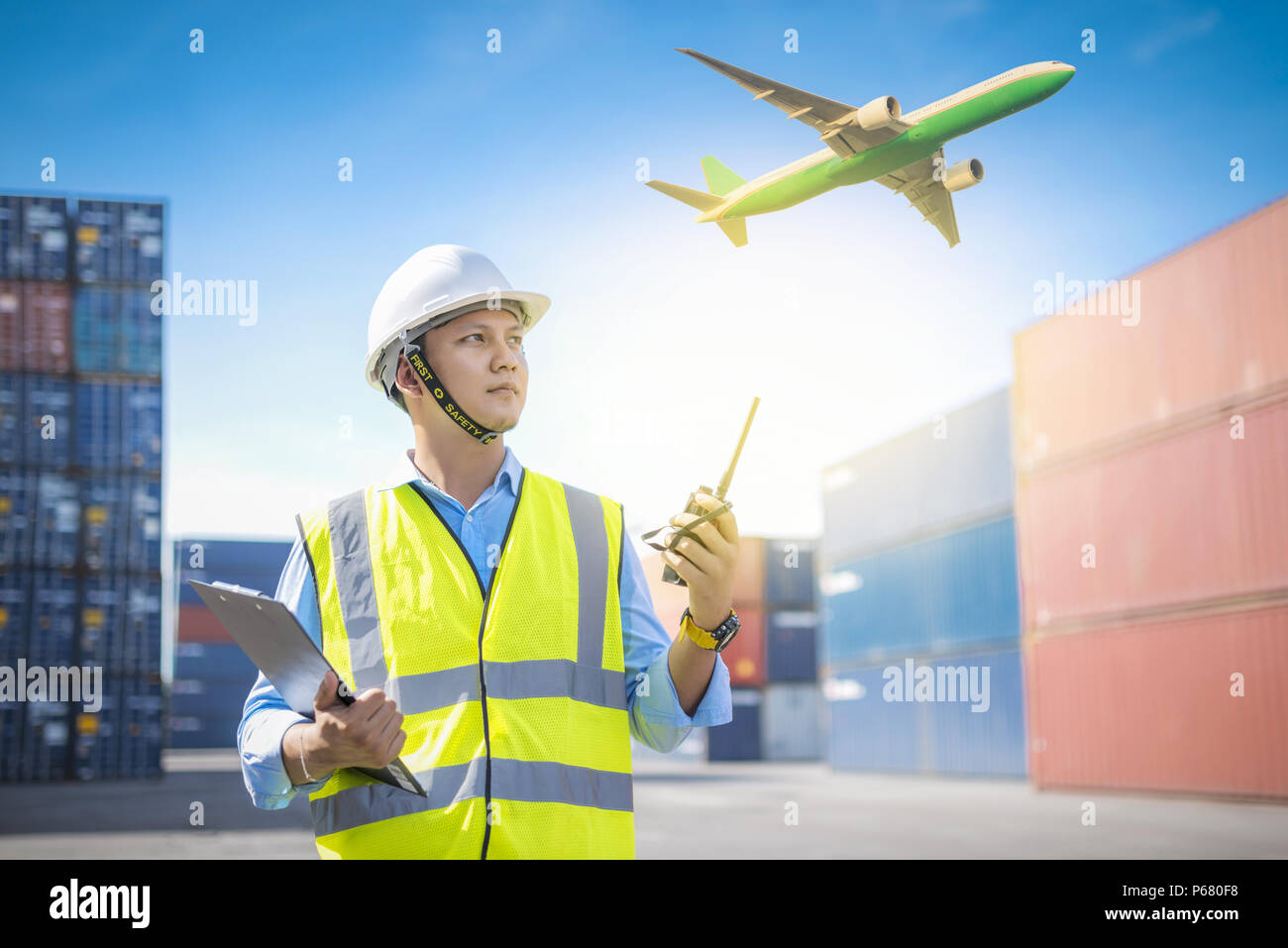Foreman control loading containers box from cargo freight ship for ...