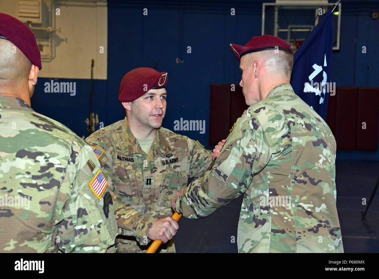 Capt. Jonathon Mathias, center, passes the guidon to Lt. Col. Michael ...