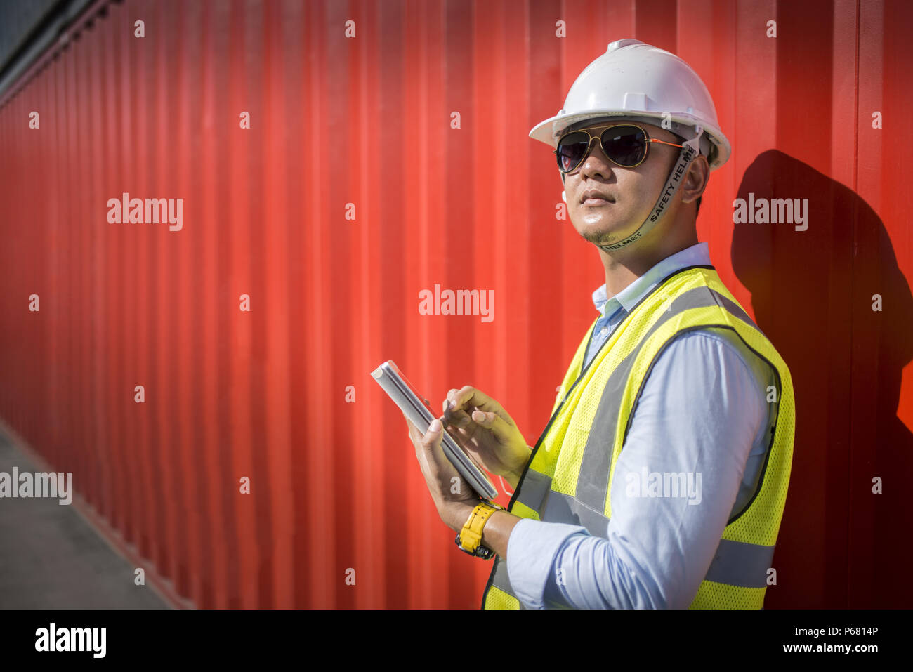 Foreman control loading containers box from cargo freight ship for ...