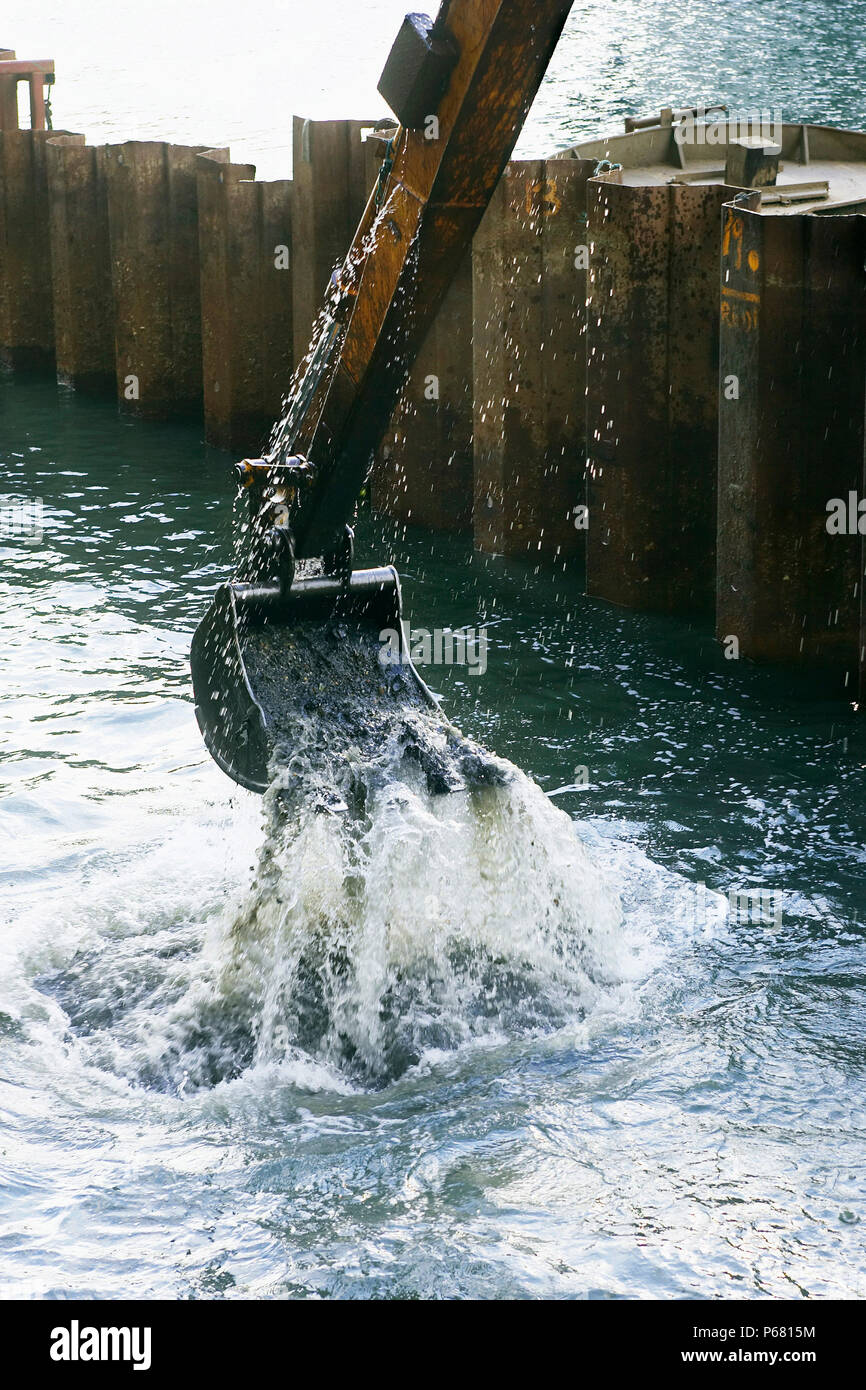 Excavator bucket during dredging excavations Stock Photo - Alamy