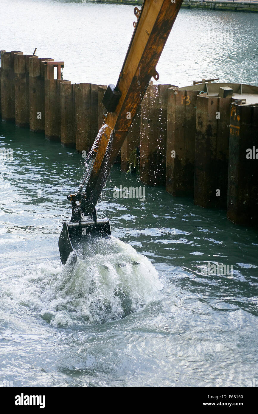 Excavator bucket during dredging excavations Stock Photo - Alamy