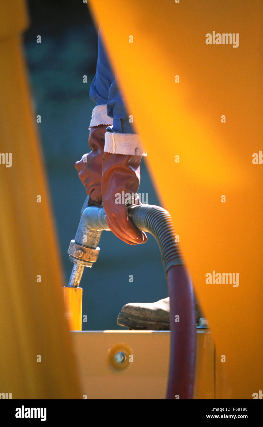 Plant opeartor filling petrol tank Stock Photo - Alamy