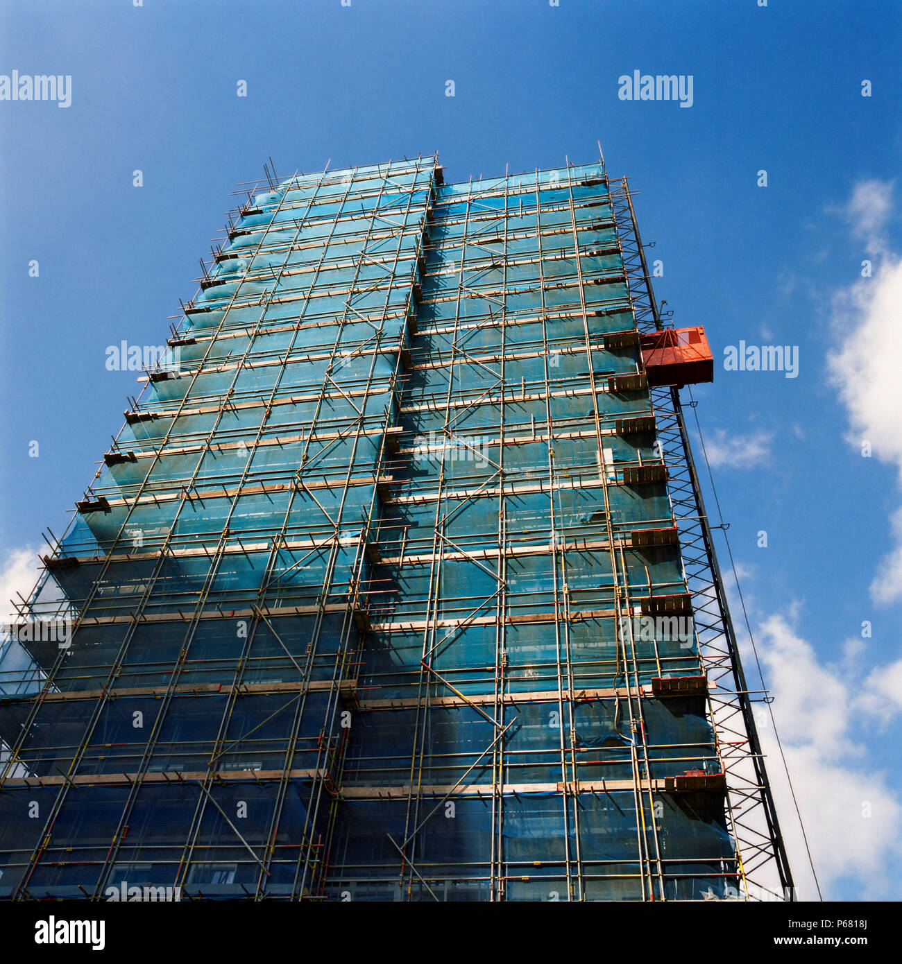 Scaffolding erected over full height of tower block Stock Photo - Alamy