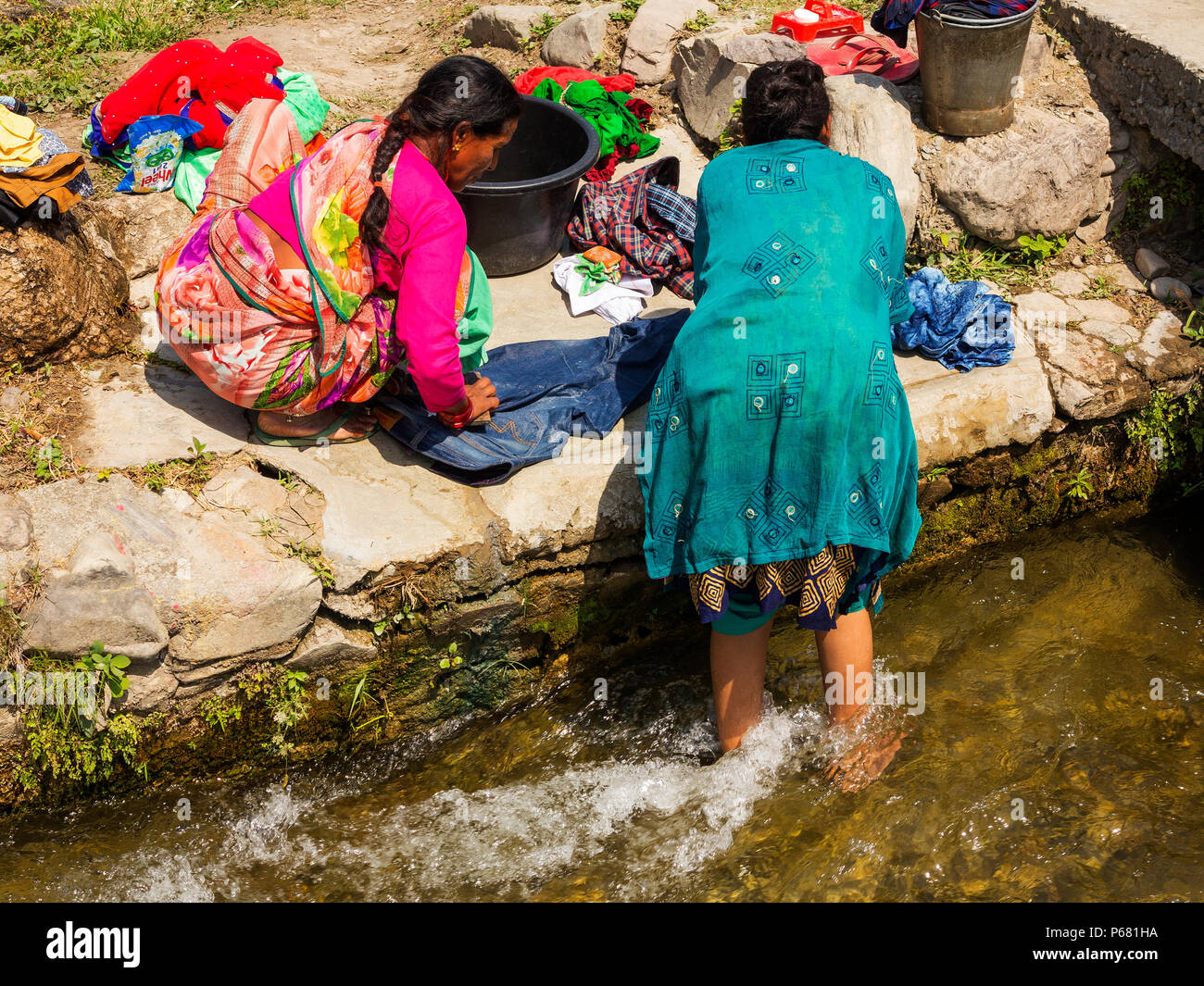 Indian woman washing clothes at the canal, Pawalgarh, Uttarakhand ...