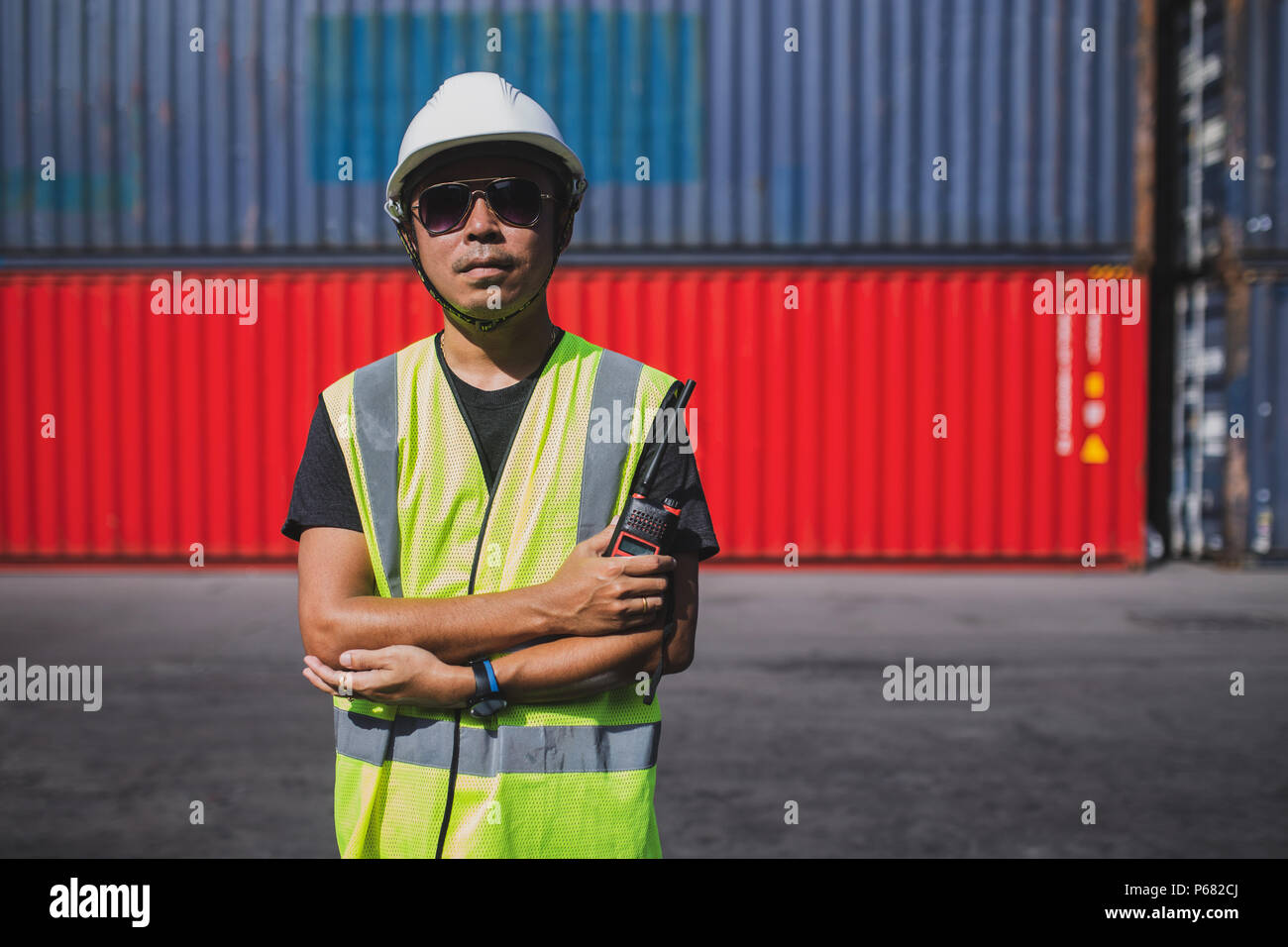 Foreman control loading containers box from cargo freight ship for ...