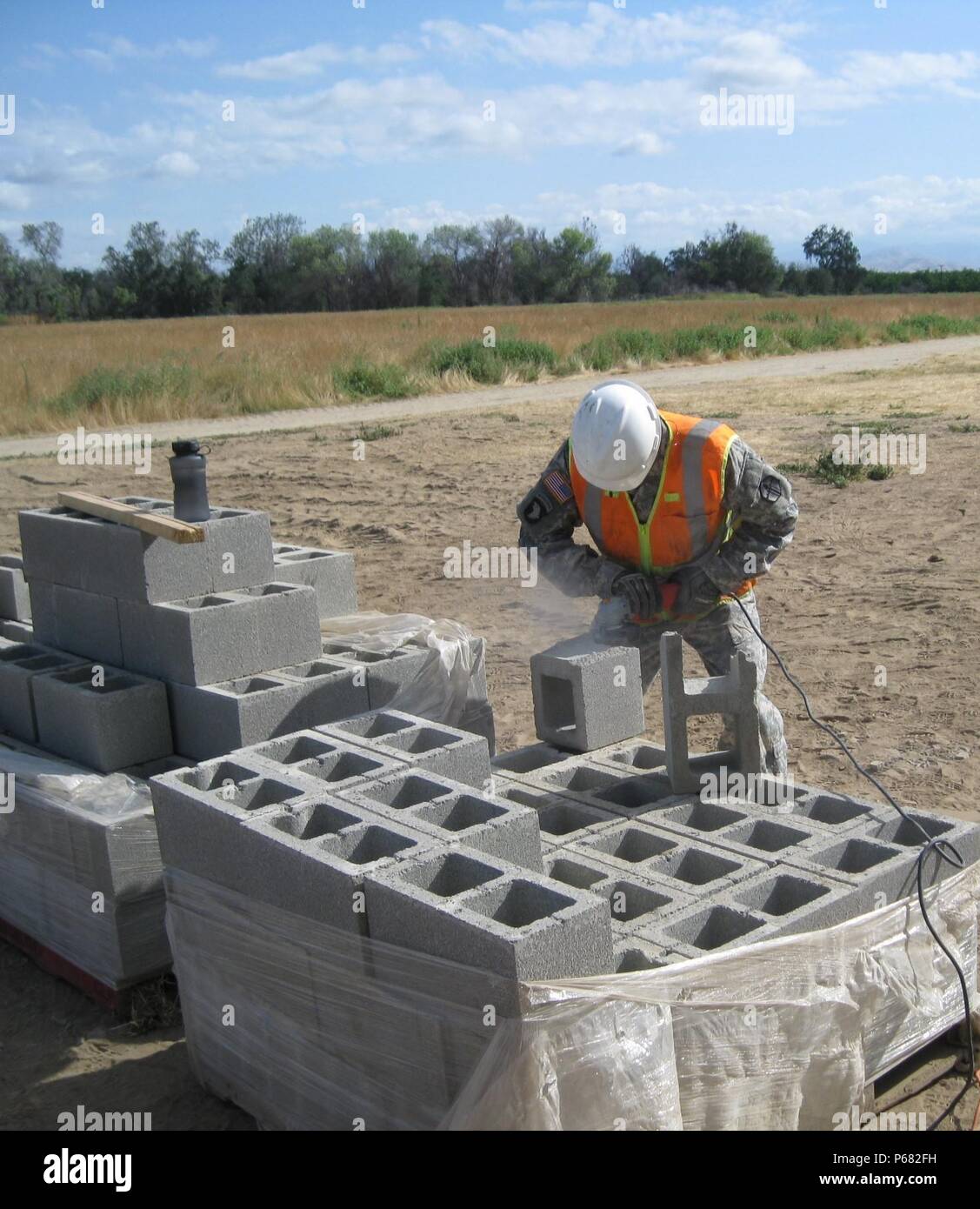 A Soldier from the 672nd Engineer Company cuts a cement block during ...