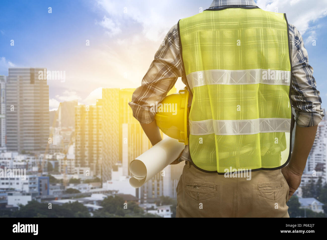 Close up engineers working on a building site holding a blueprints ...
