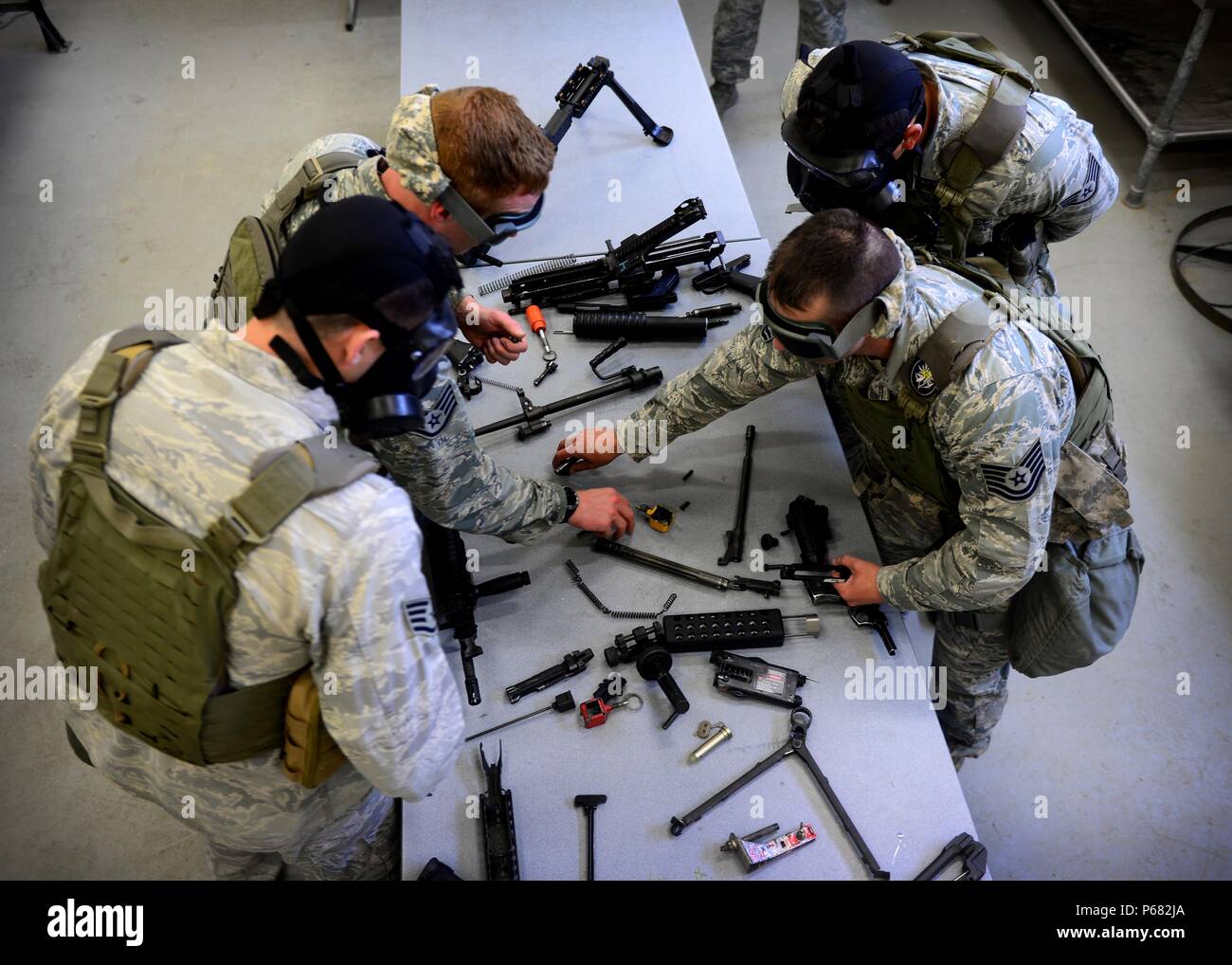 Airmen assigned to the 31st Security Forces Squadron, assemble weapons ...