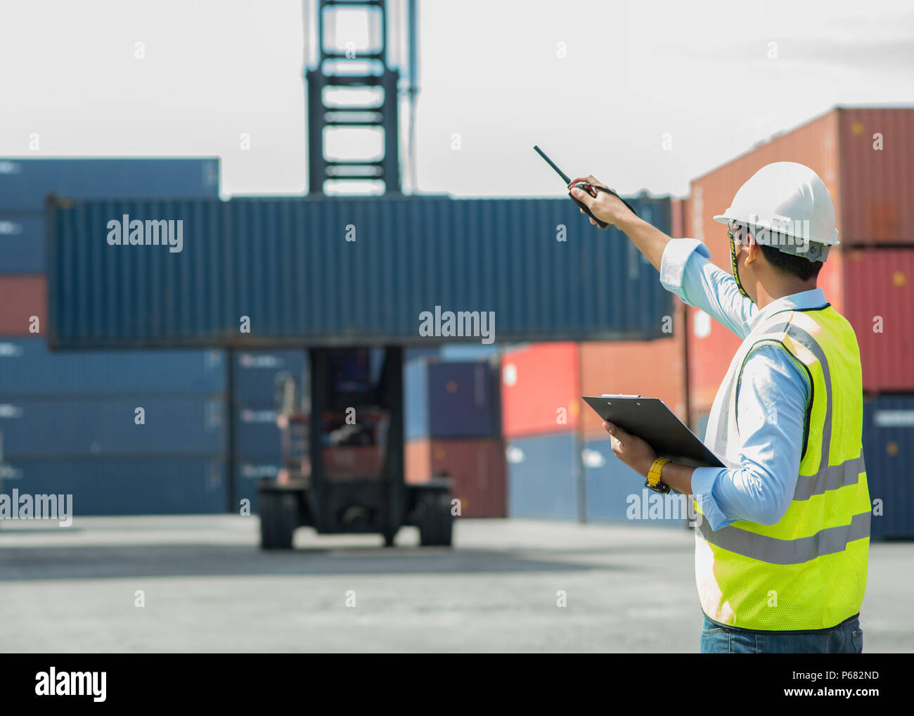 Foreman control loading containers box from cargo freight ship for ...