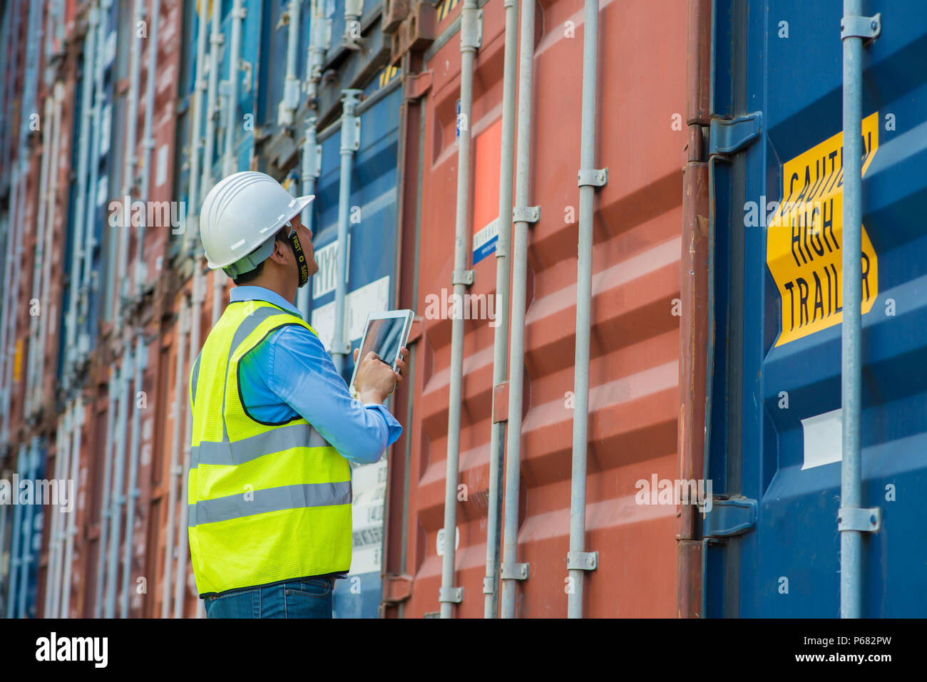 Foreman control loading containers box from cargo freight ship for ...