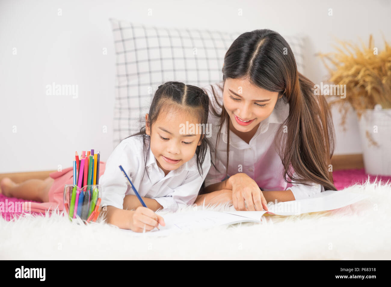 Young family drawing together with colorful pencils at home Stock Photo ...