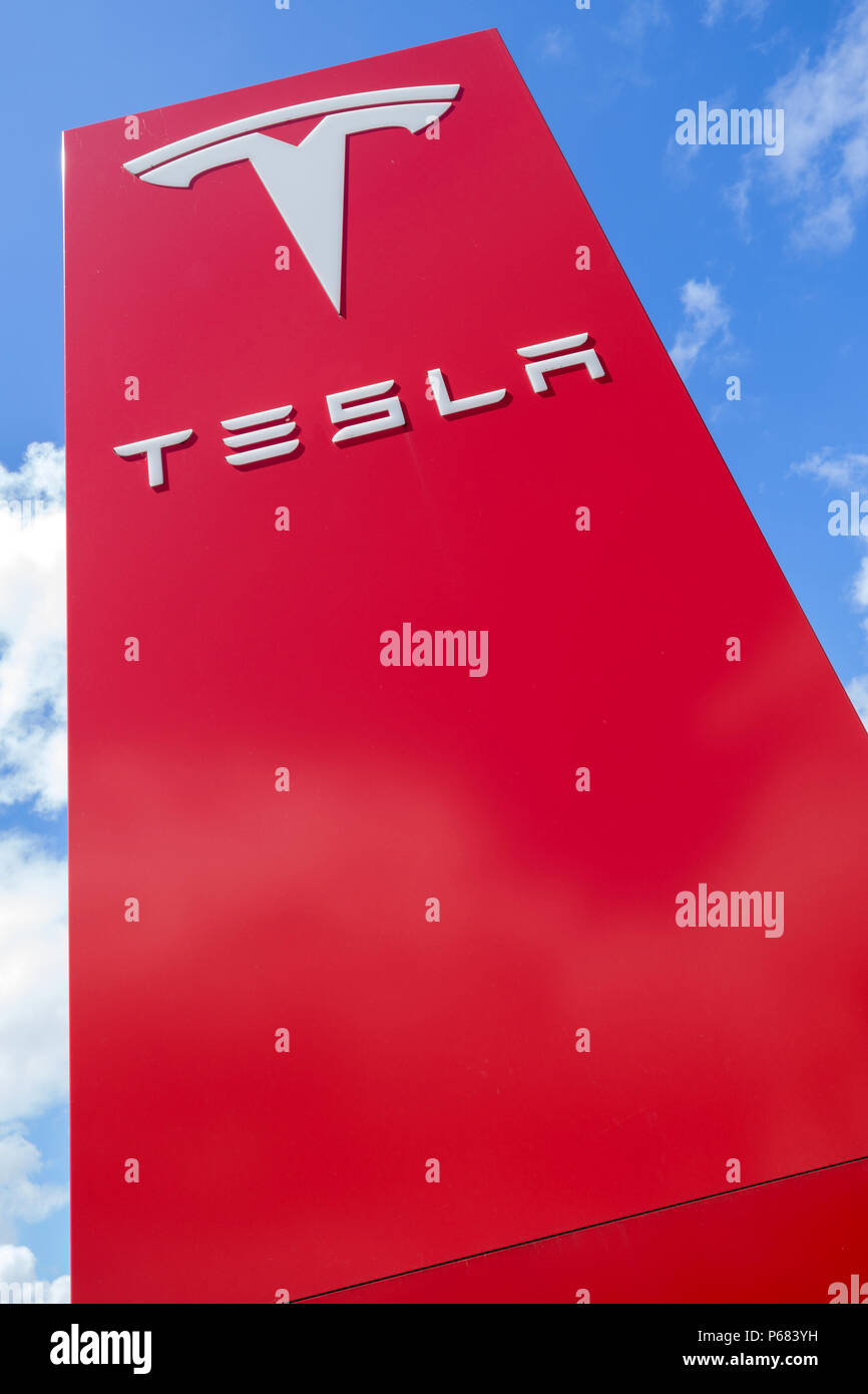 Tesla dealership sign against blue sky Stock Photo - Alamy