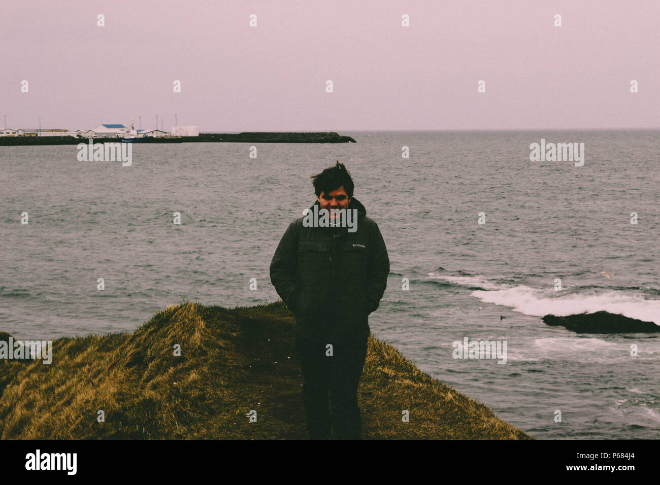 Young male 20-25 embracing the nature of Iceland in dramatic photos off ...