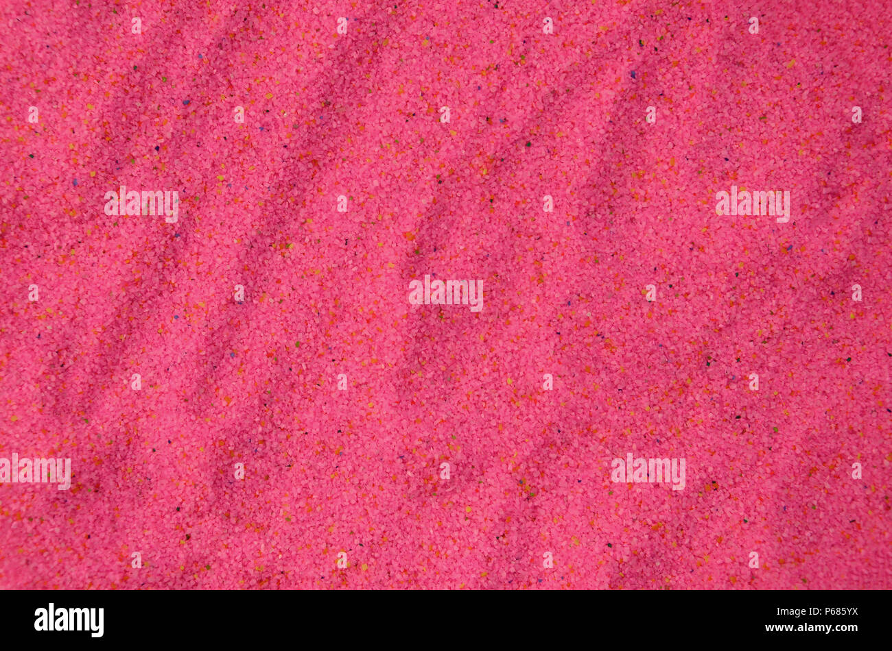 Texture of a colored granular sand close up. Pink grains Stock Photo ...