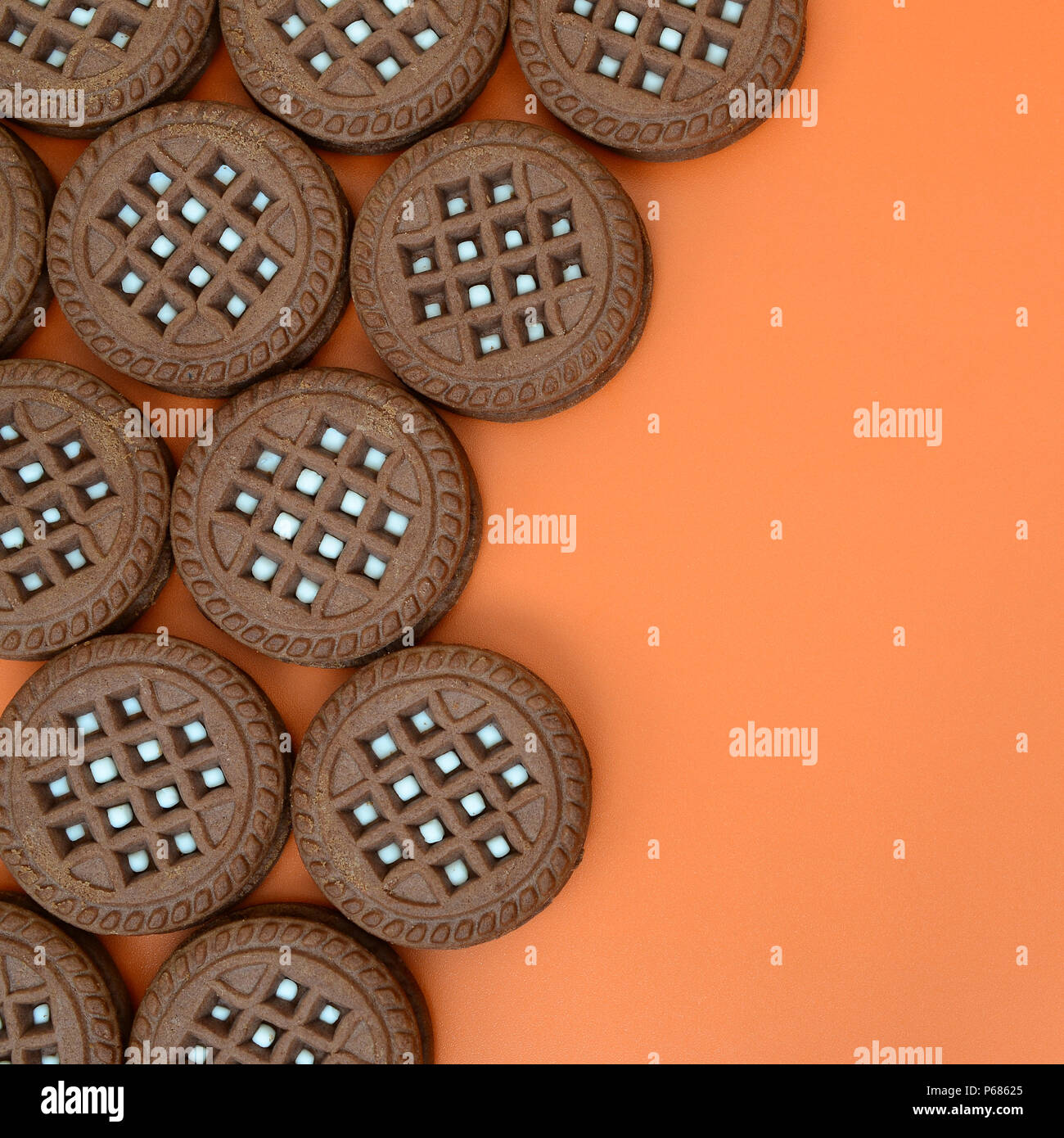 Detailed picture of dark brown round sandwich cookies with coconut ...