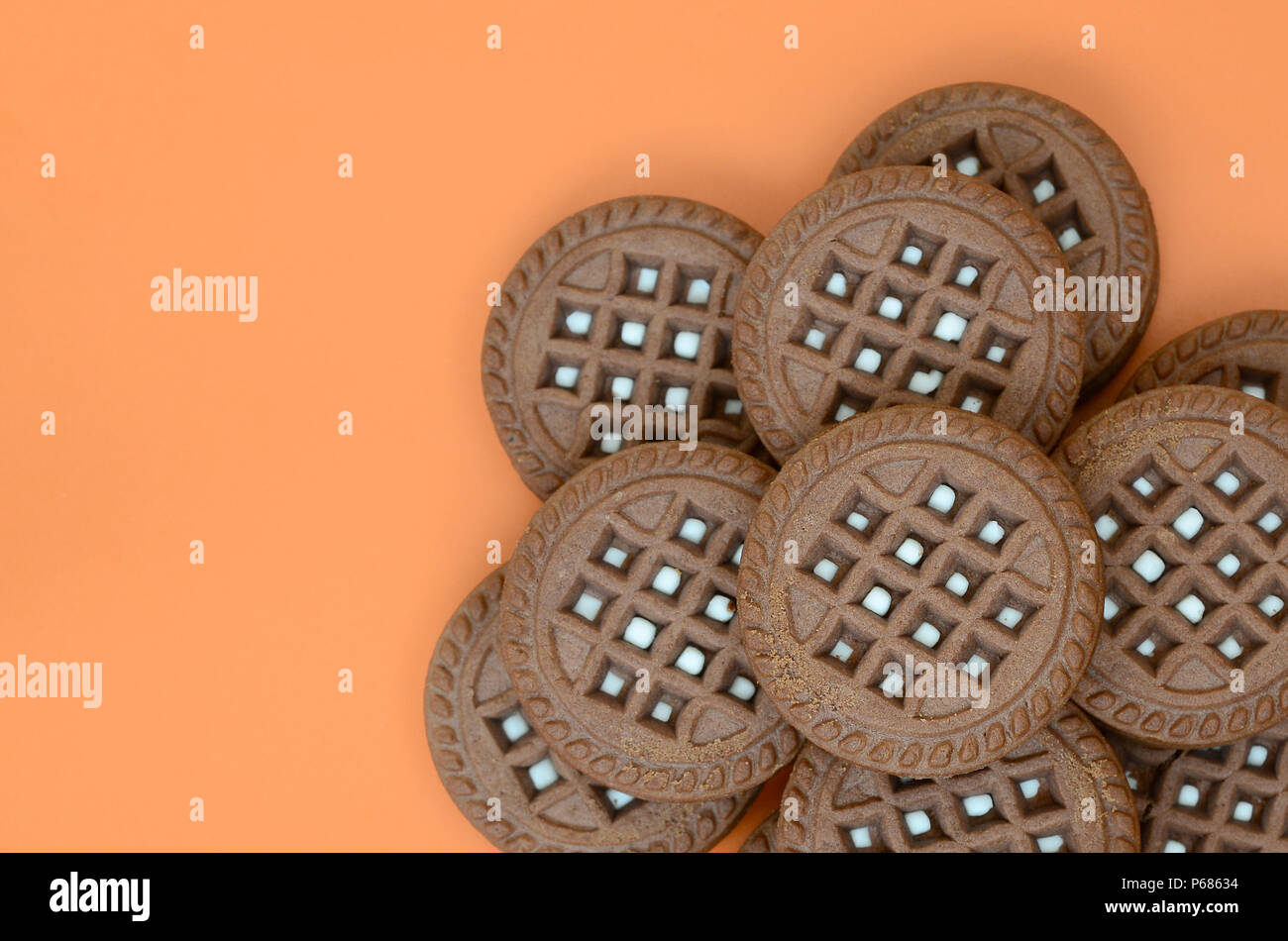 Detailed picture of dark brown round sandwich cookies with coconut ...