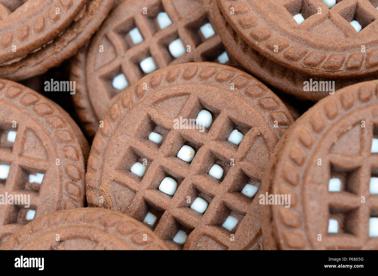 Detailed picture of dark brown round sandwich cookies with coconut ...