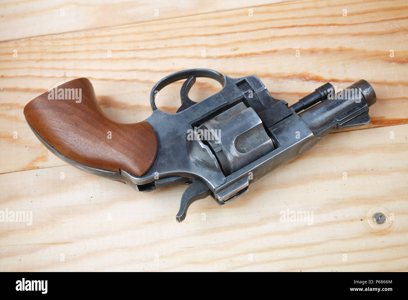 Revolver on the wooden table background Stock Photo - Alamy