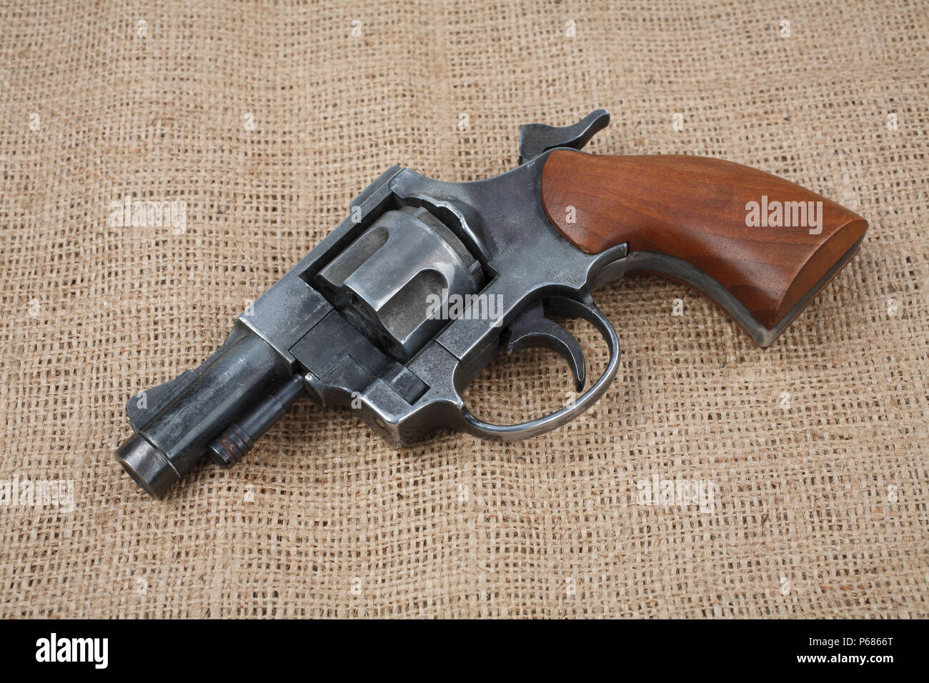 Revolver on the canvas background Stock Photo - Alamy