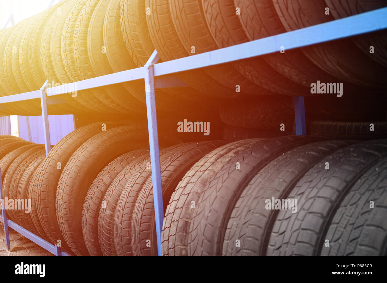 Rack with variety of car tires in automobile store. Many black tires ...