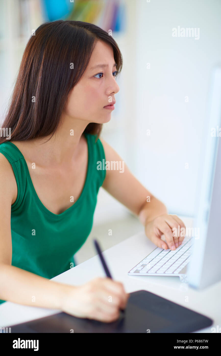 One Young Chinese Woman Working in the Home office with Computer Stock ...