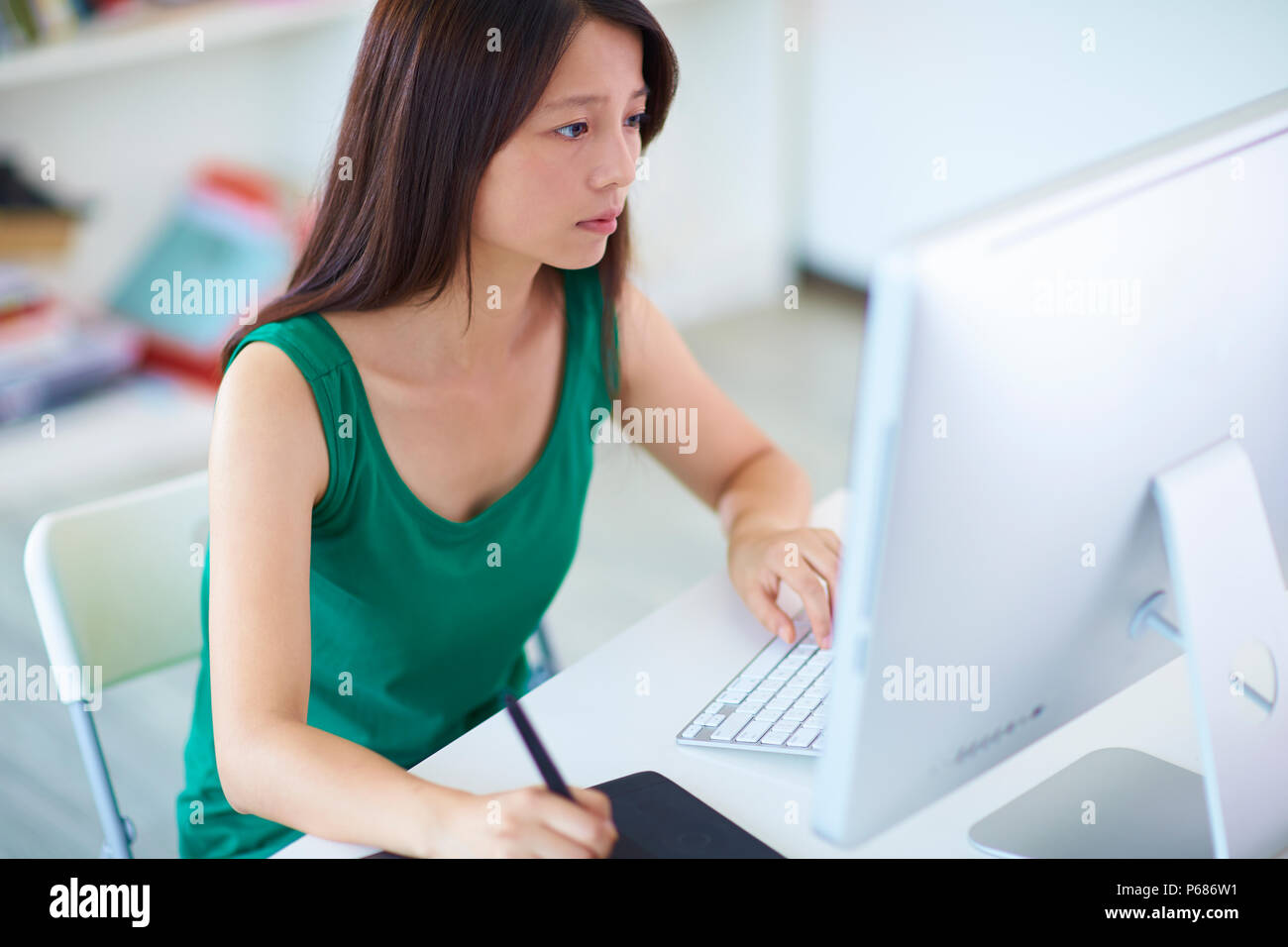 One Young Chinese Woman Working in the Home office with Computer Stock ...