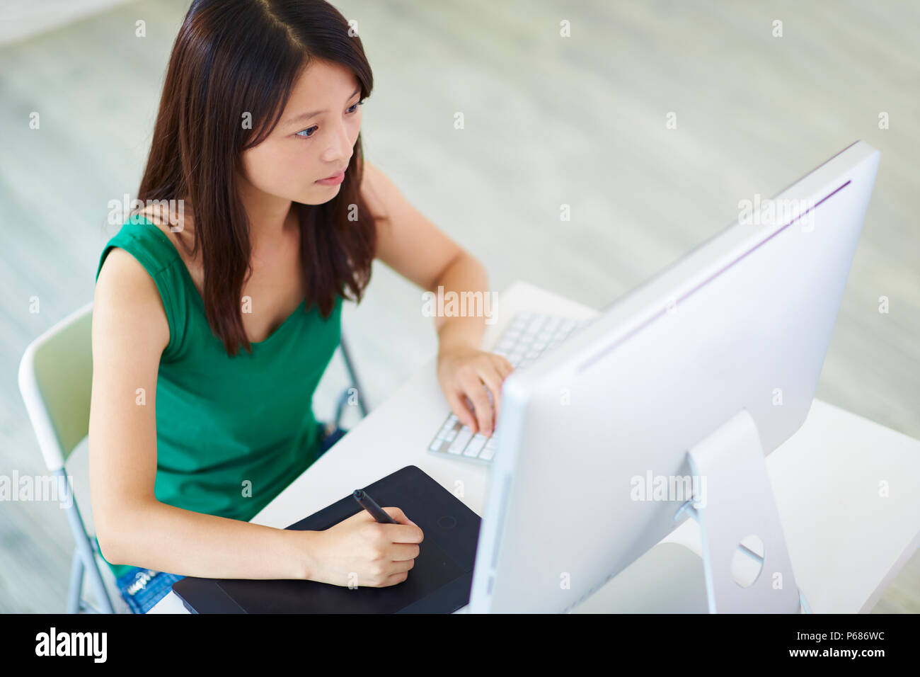 One Young Chinese Woman Working in the Home office with Computer Stock ...