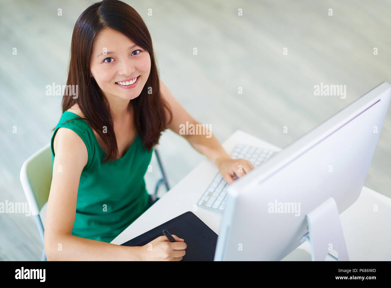 One Young Chinese Woman Working in the Home office with Computer Stock ...