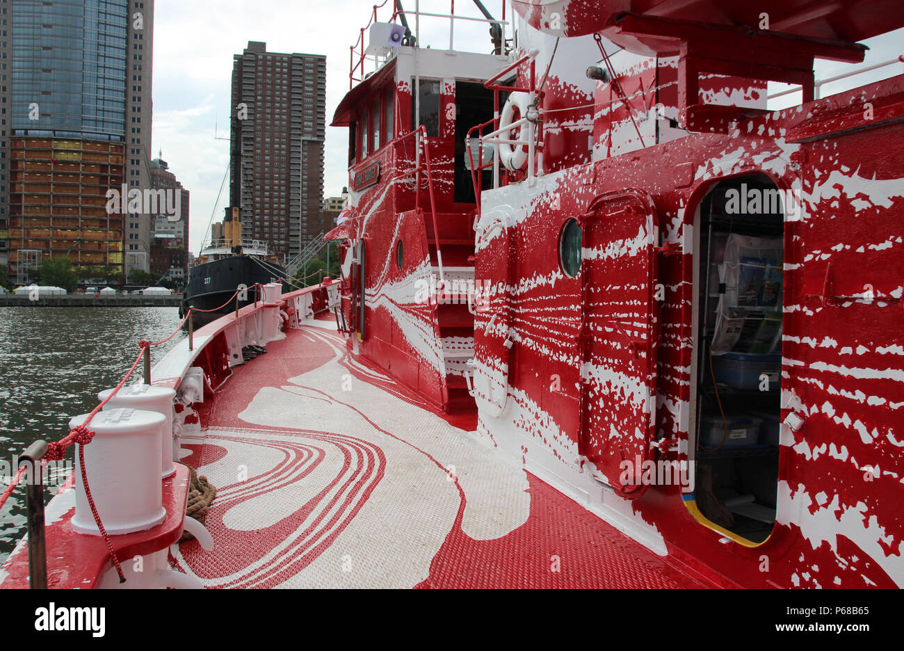 27 June 2018, USA, New York. An old fireboat painted red-and-white ...