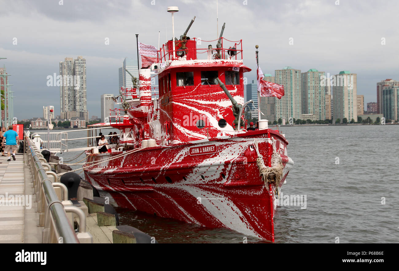 27 June 2018, USA, New York. An old fireboat painted red-and-white ...
