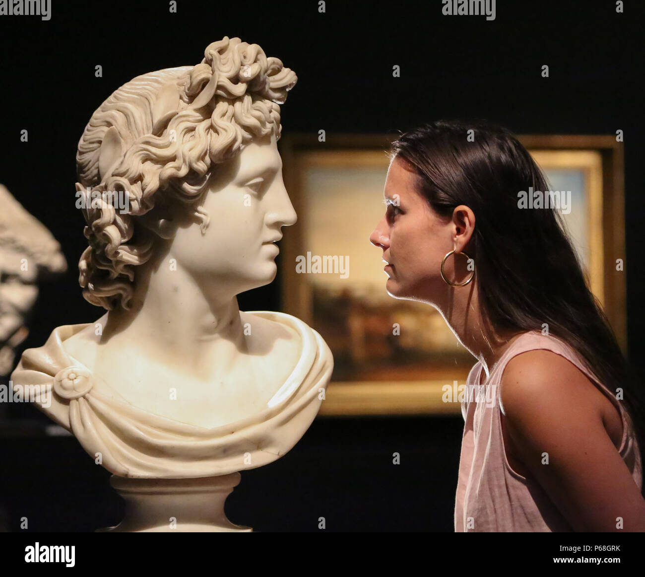 Sotheby's London. UK 29 June 2018 - A woman looks Bust of the Apollo ...