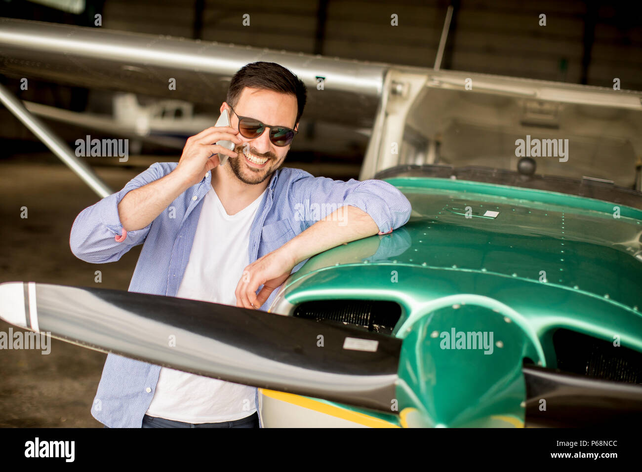 Male pilot checking airplane wing hi-res stock photography and images ...