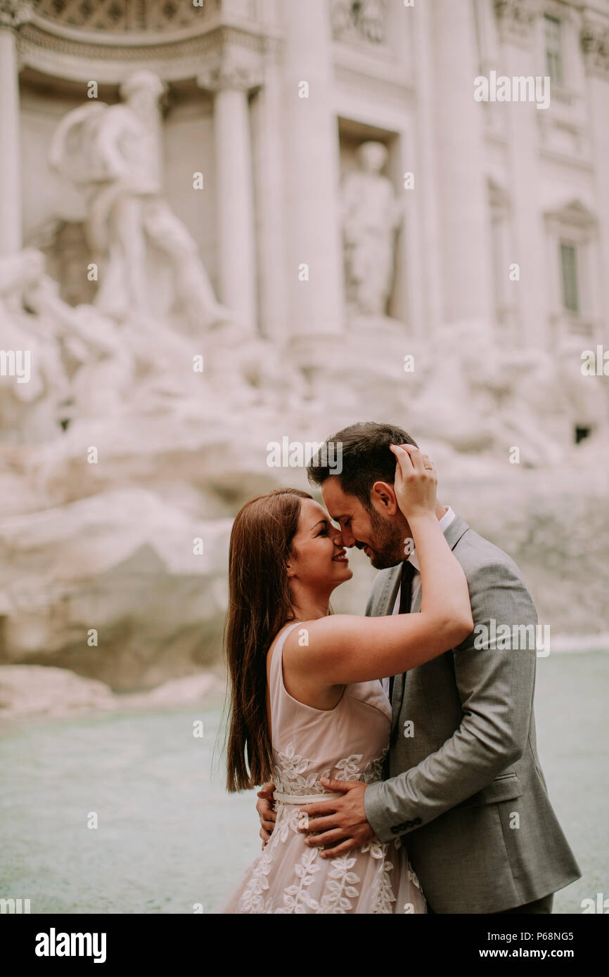 Just married bride and groom posing in front of Trevi Fountain (Fontana ...